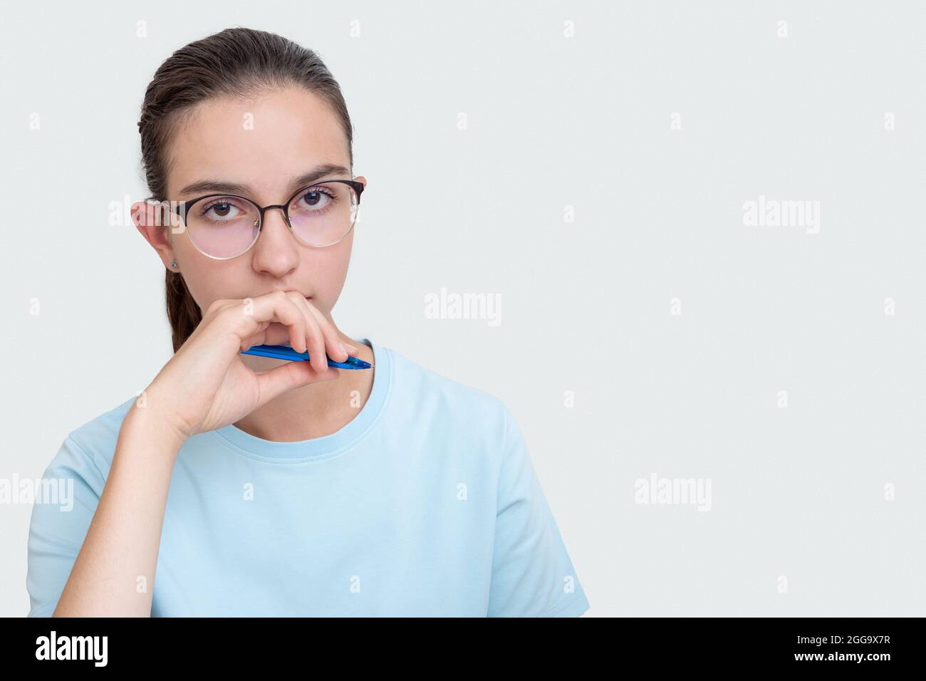 Woman thinking glasses in mouth hi-res stock photography and images - Alamy