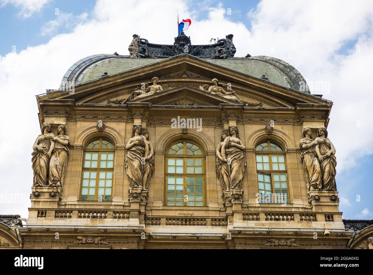 Low angle shot of the Louvre building under a blue cloudy sky Stock ...
