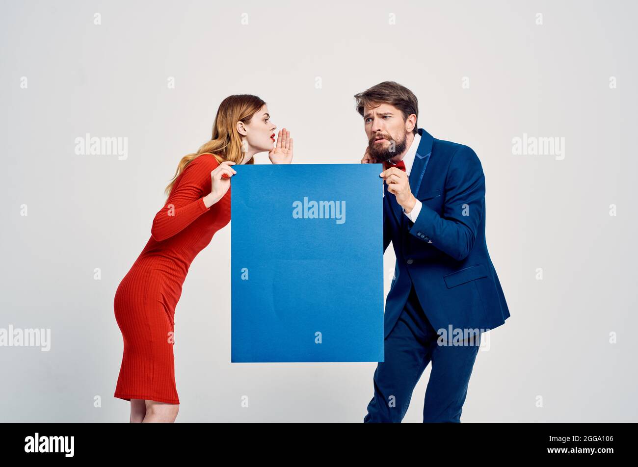 man in suit next to woman in red dress blue mocap poster Stock Photo ...