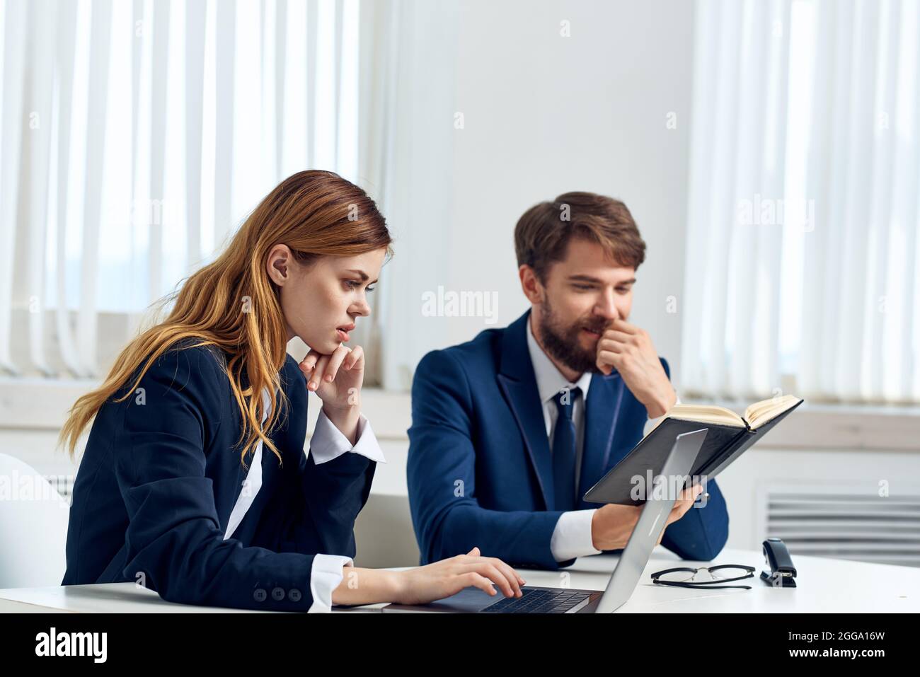 man and woman managers work together in front of laptop team technology ...