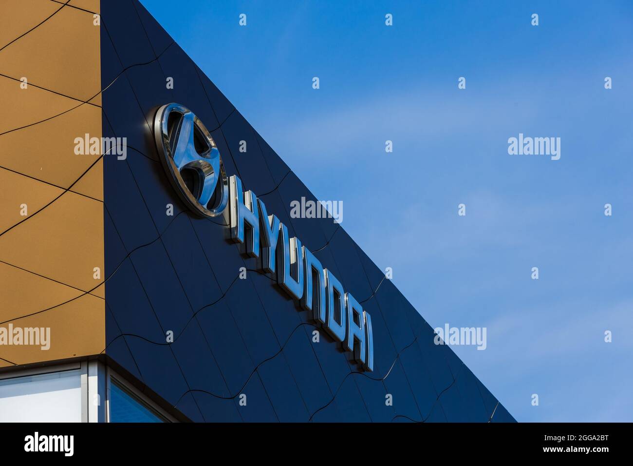 Hyundai logo on car dealership building at sunny day - Hyundai is a ...