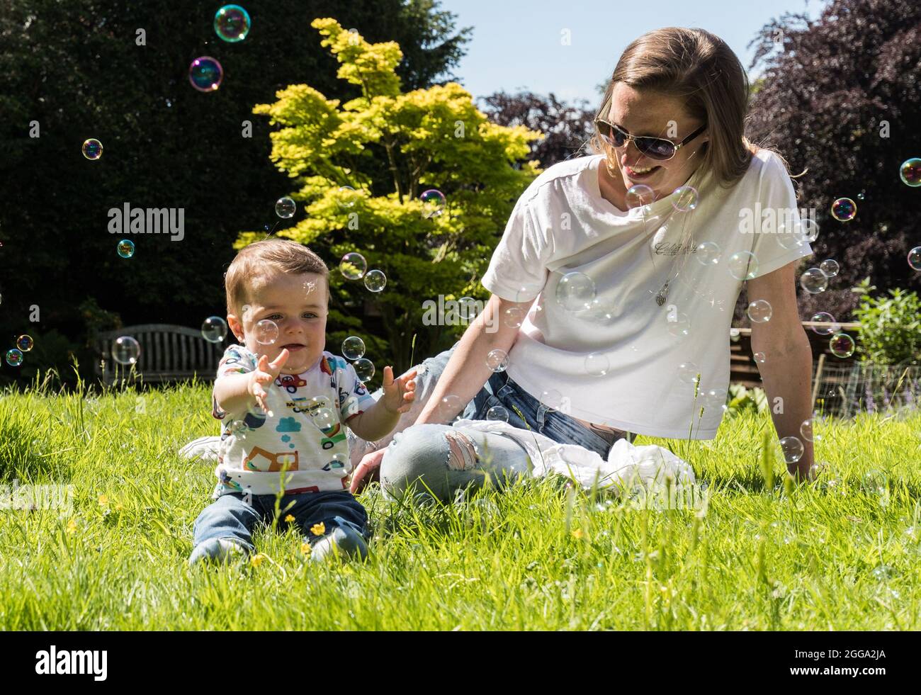 child trying to catch bubbles Stock Photo - Alamy