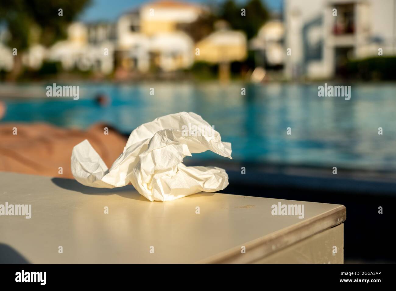 Used Paper Tissue in front of a Hotel Pool Stock Photo - Alamy