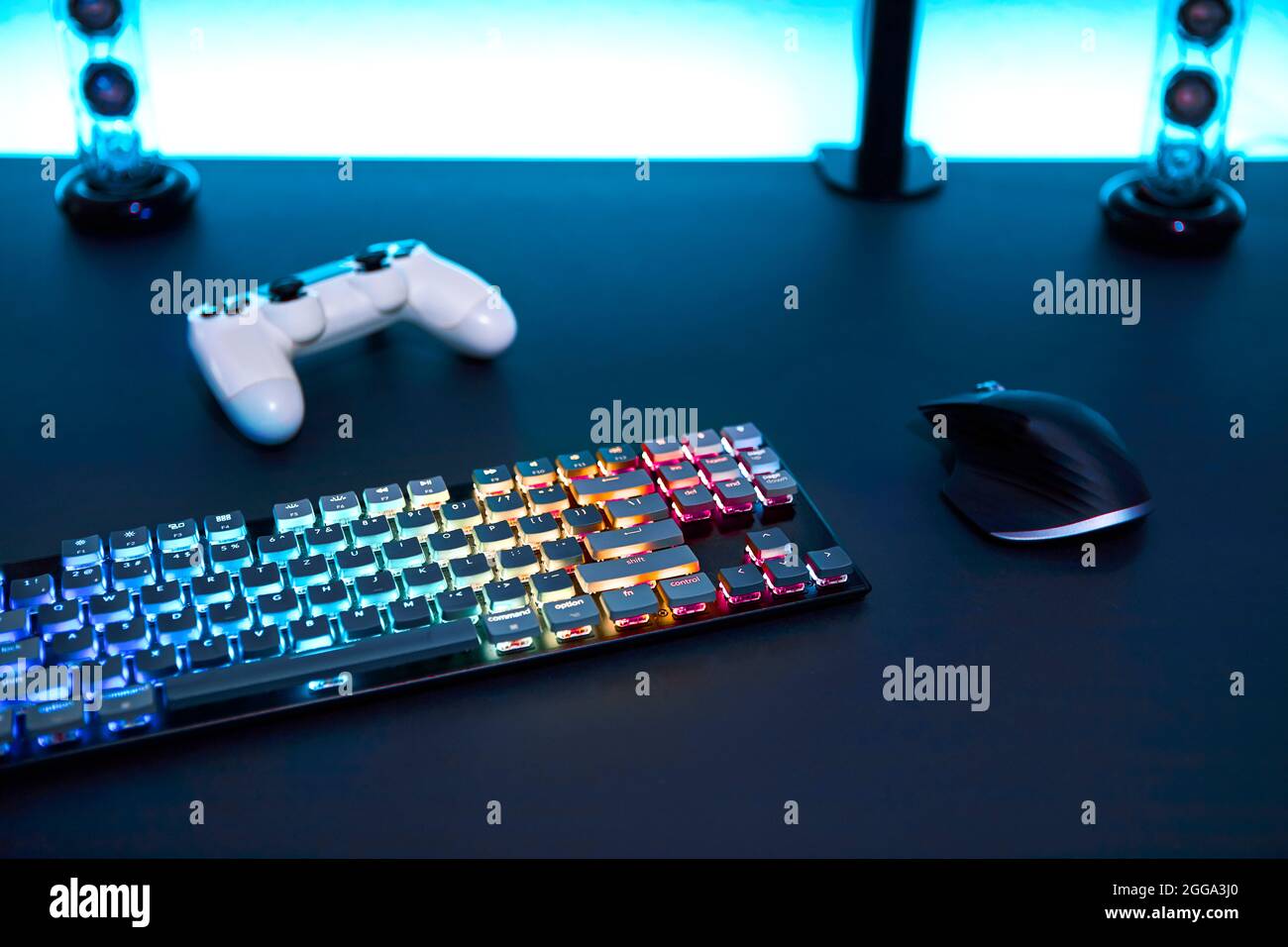 Clean workplace of gamer. Various color backlighted gaming accessories ...