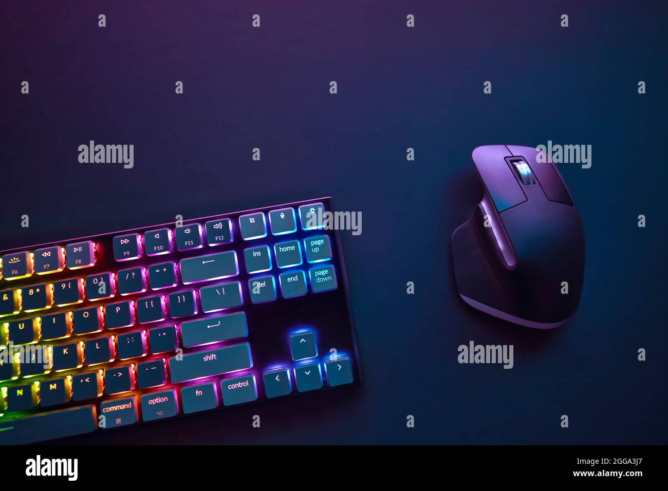 Top down view of vivid color backlighted computer keyboard and mouse ...