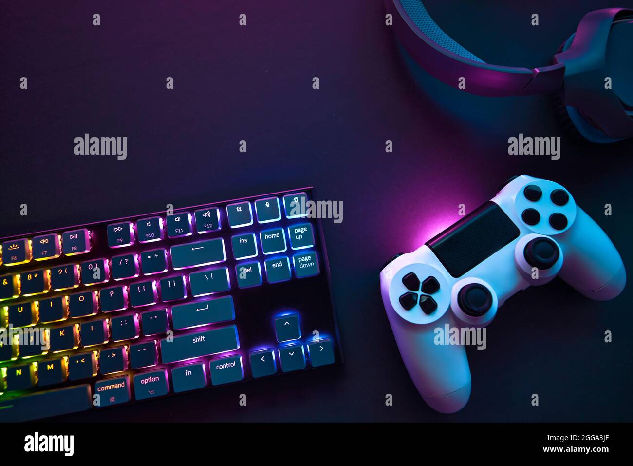 Top down view of colorful illuminated gaming accessories laying on ...