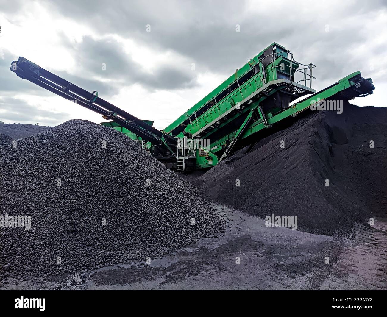 A loader harvester for loading bulk cargo drives onto a pile of granite ...
