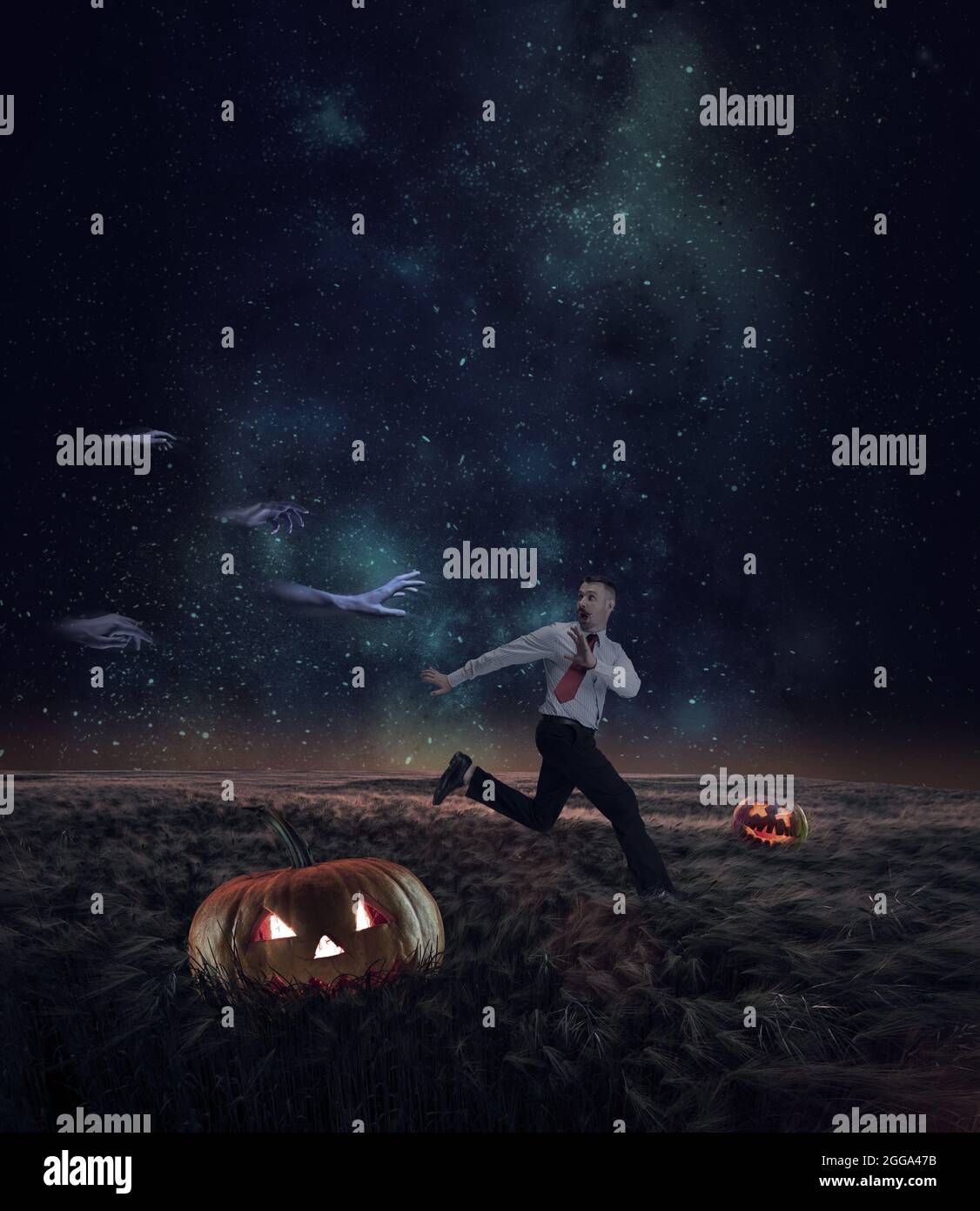 Terrifying man running away from ghost hands at night Stock Photo - Alamy
