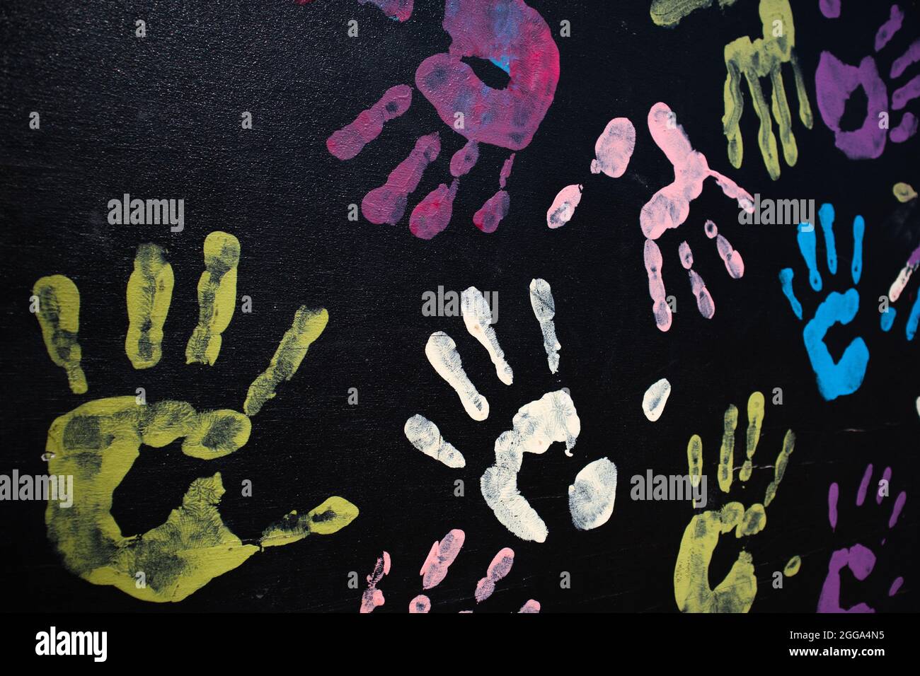 Colorful Children's Hand Prints Decorate a Black Wall - Photo Stock ...