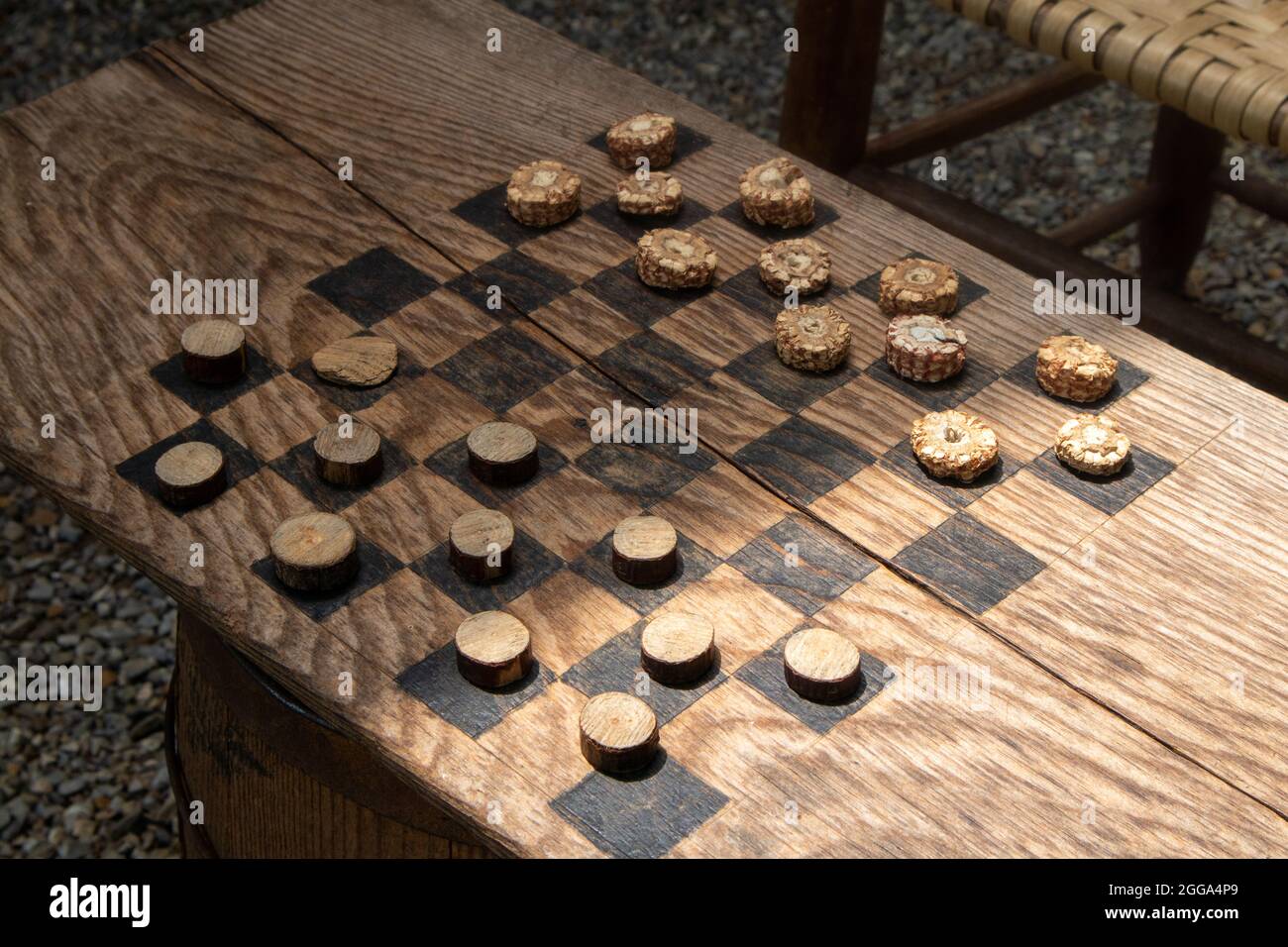 Checkers game made from wood and corn cob pieces Stock Photo - Alamy