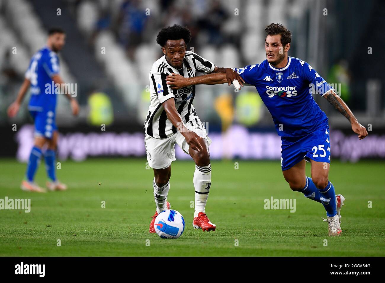 Turin, Italy. 28 August 2021. Juan Cuadrado (L) of Juventus FC is ...