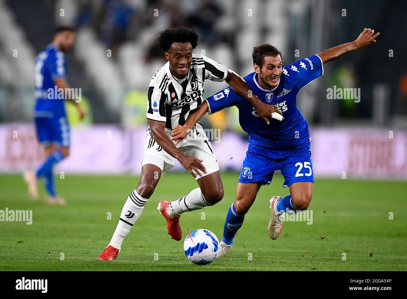 Turin, Italy. 28 August 2021. Juan Cuadrado (L) of Juventus FC is ...