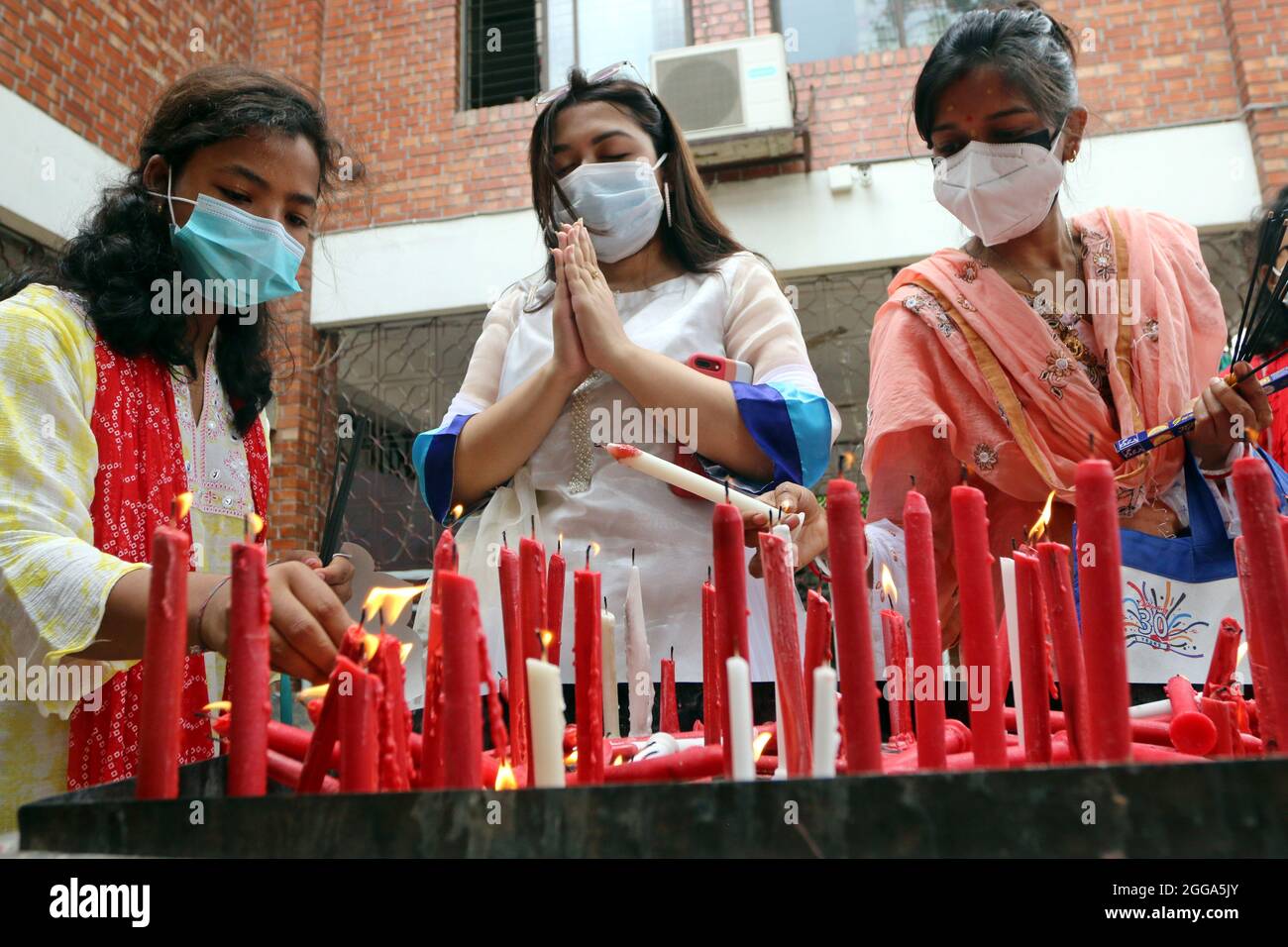 Dhaka, Bangladesh. 30th Aug, 2021. A Devote prays while light a candle inside Iskcon temple ...