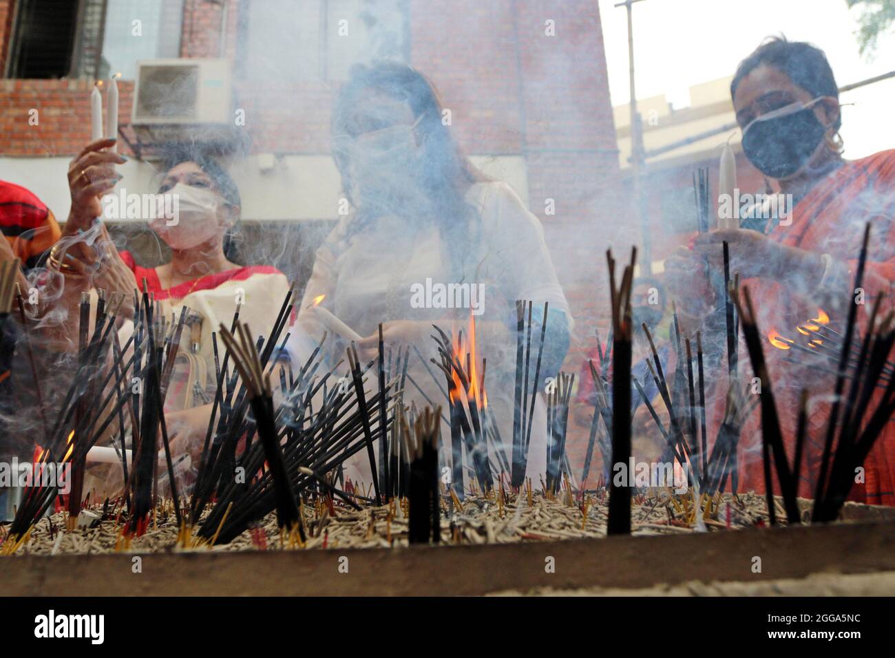 Dhaka, Bangladesh. 30th Aug, 2021. A Devote prays while holds incense ...