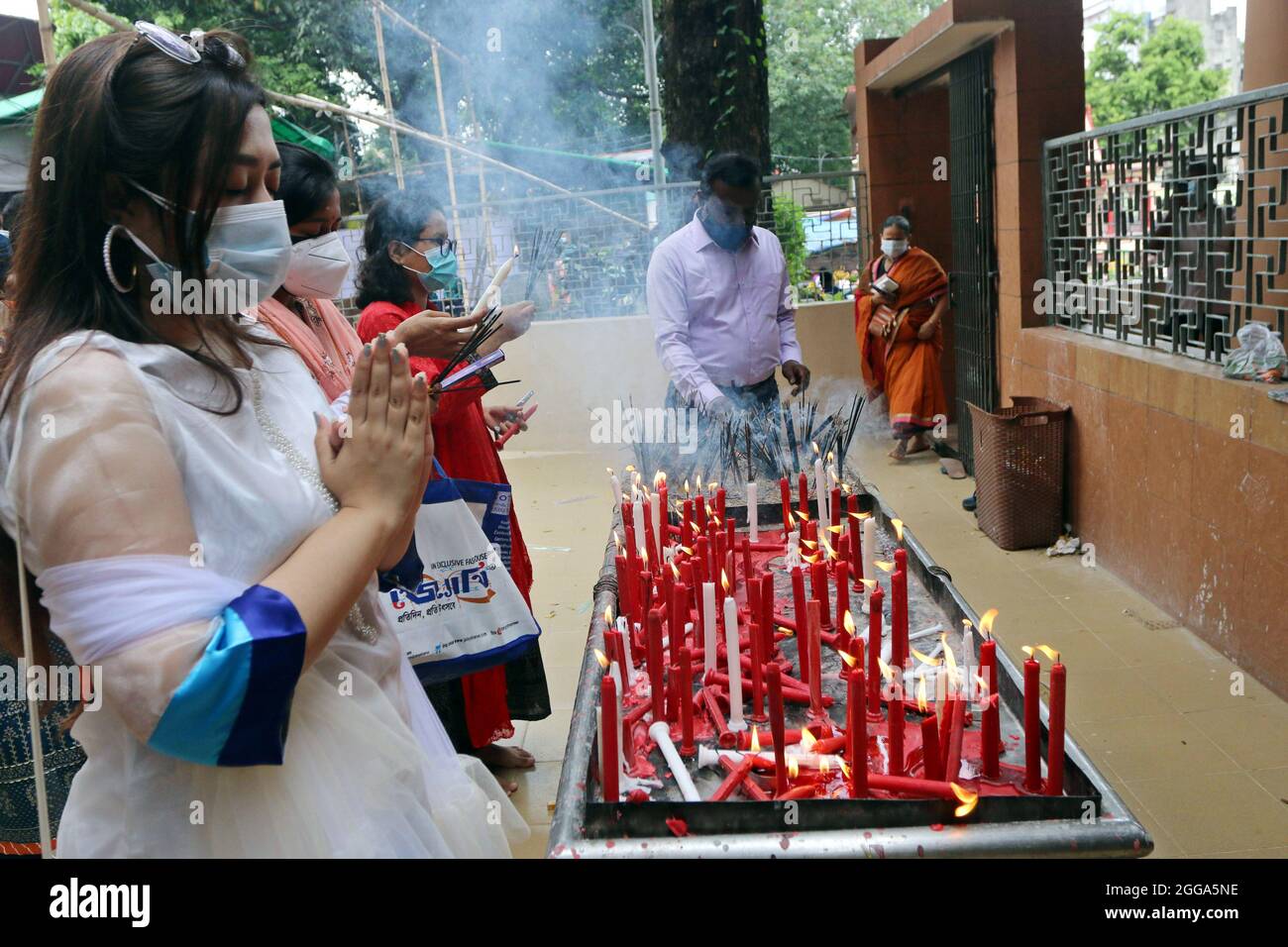 Dhaka, Bangladesh. 30th Aug, 2021. A Devote prays while light a candle inside Iskcon temple ...
