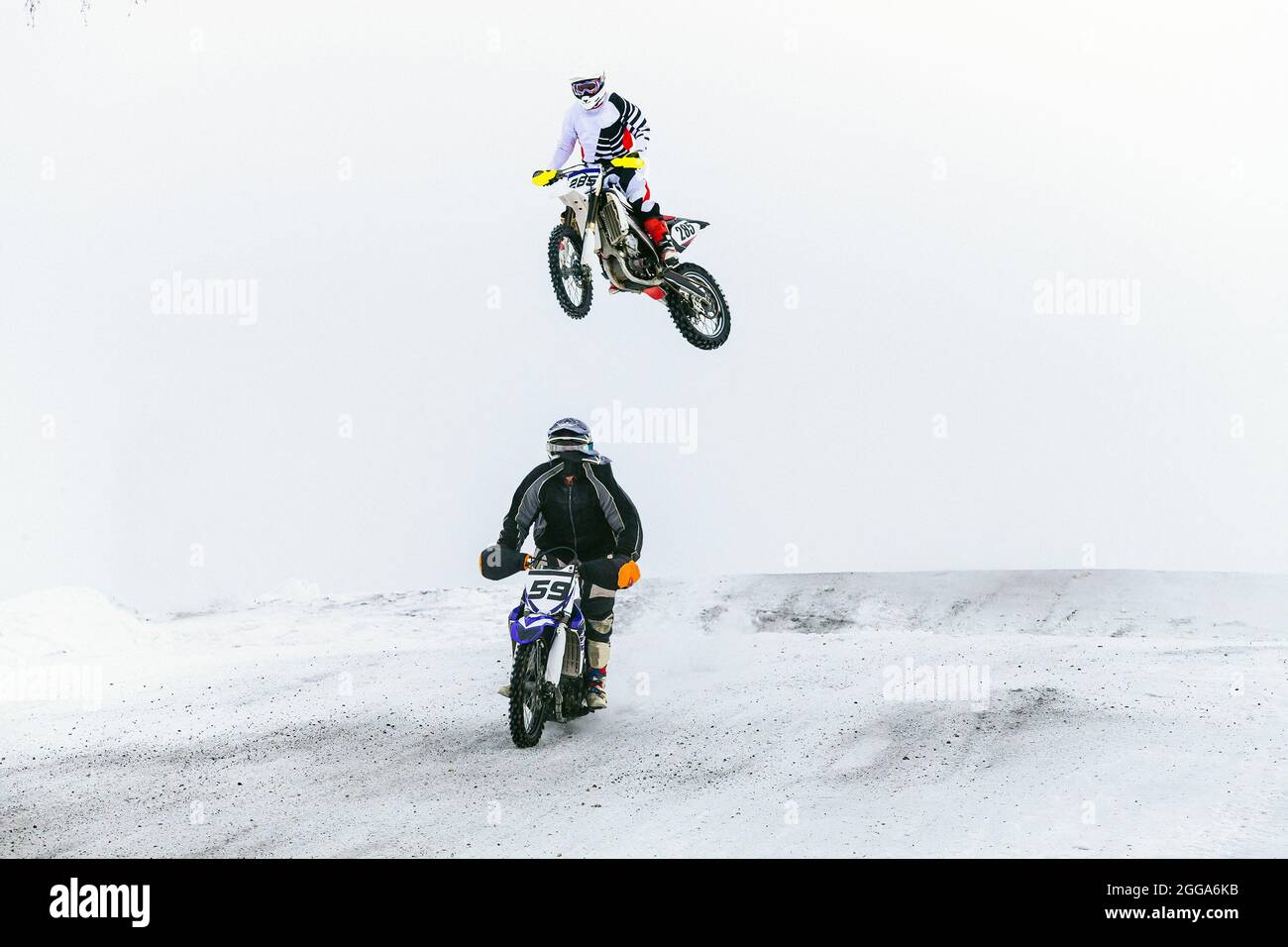 two motorcycle racers riding on snowy trail race Stock Photo - Alamy