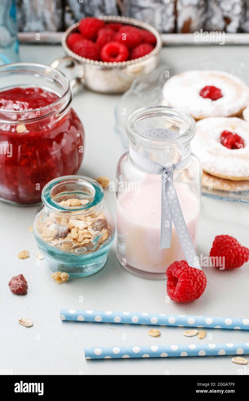 Breakfast table with yogurt, jam and jar of muesli. Healthy food Stock ...