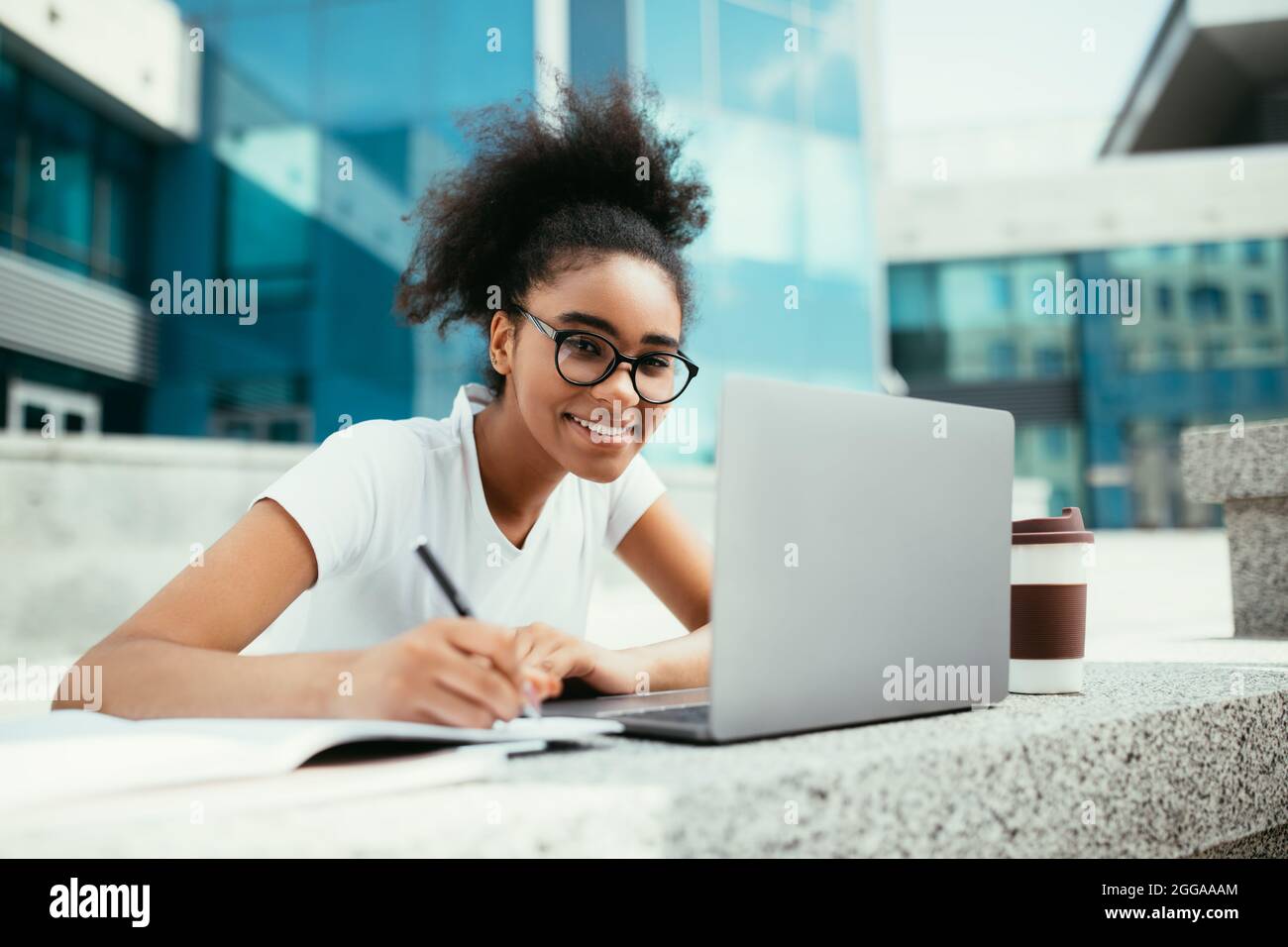 Cheerful African Student Girl Taking Notes At Laptop Outdoor Stock ...