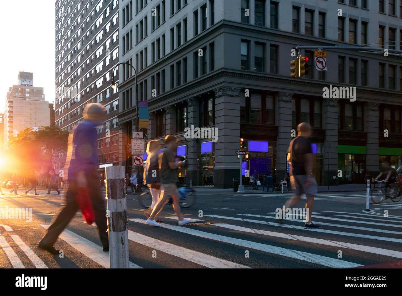 Busy intersection with people walking through the crosswalk on 14th ...
