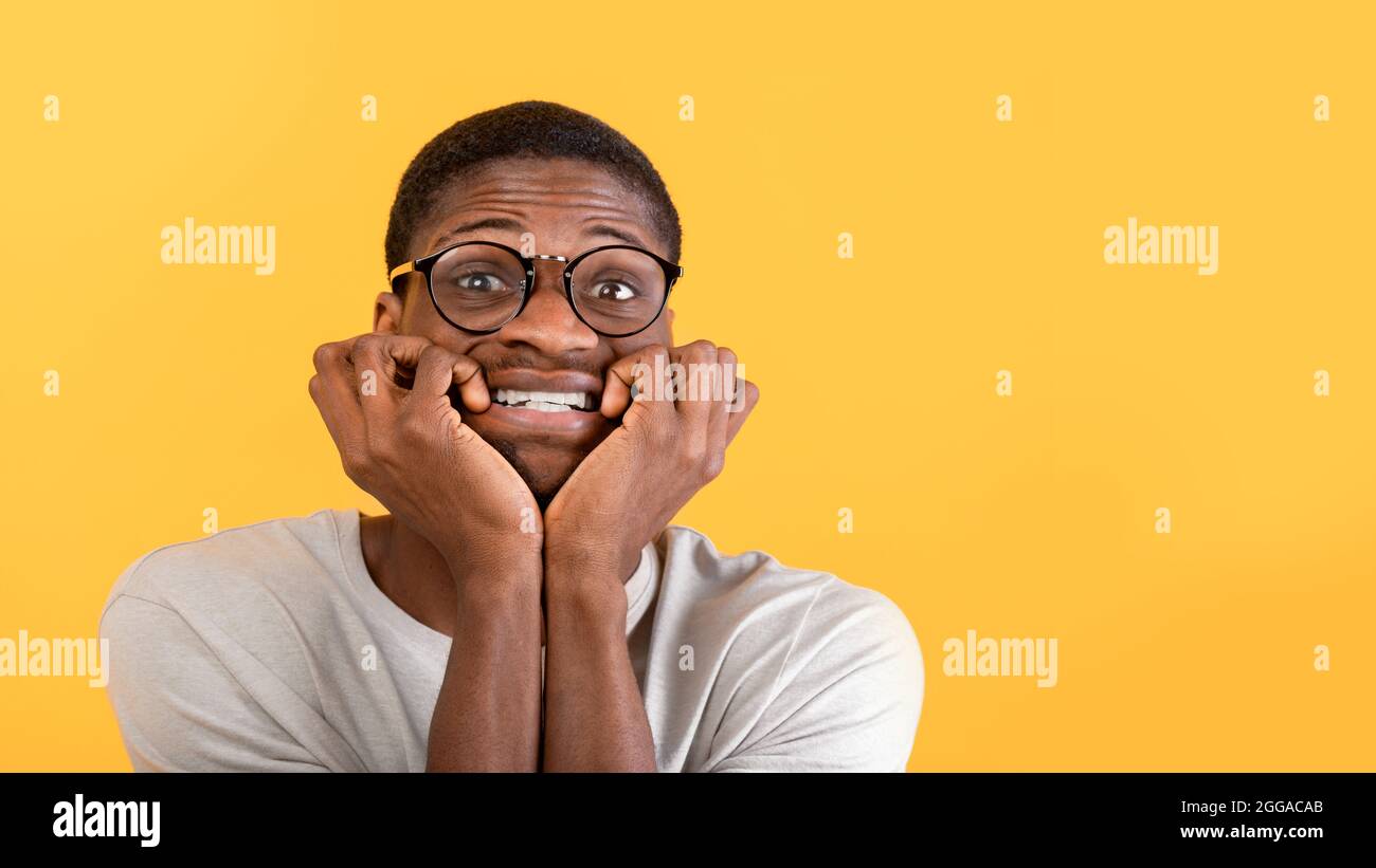 Stress control concept. Afraid black man biting nails with worry ...