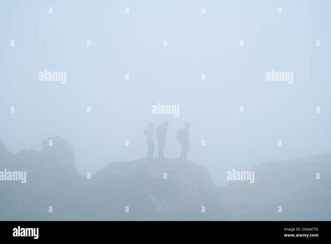 Climbers wandering on the mountain path of thick fog Stock Photo - Alamy