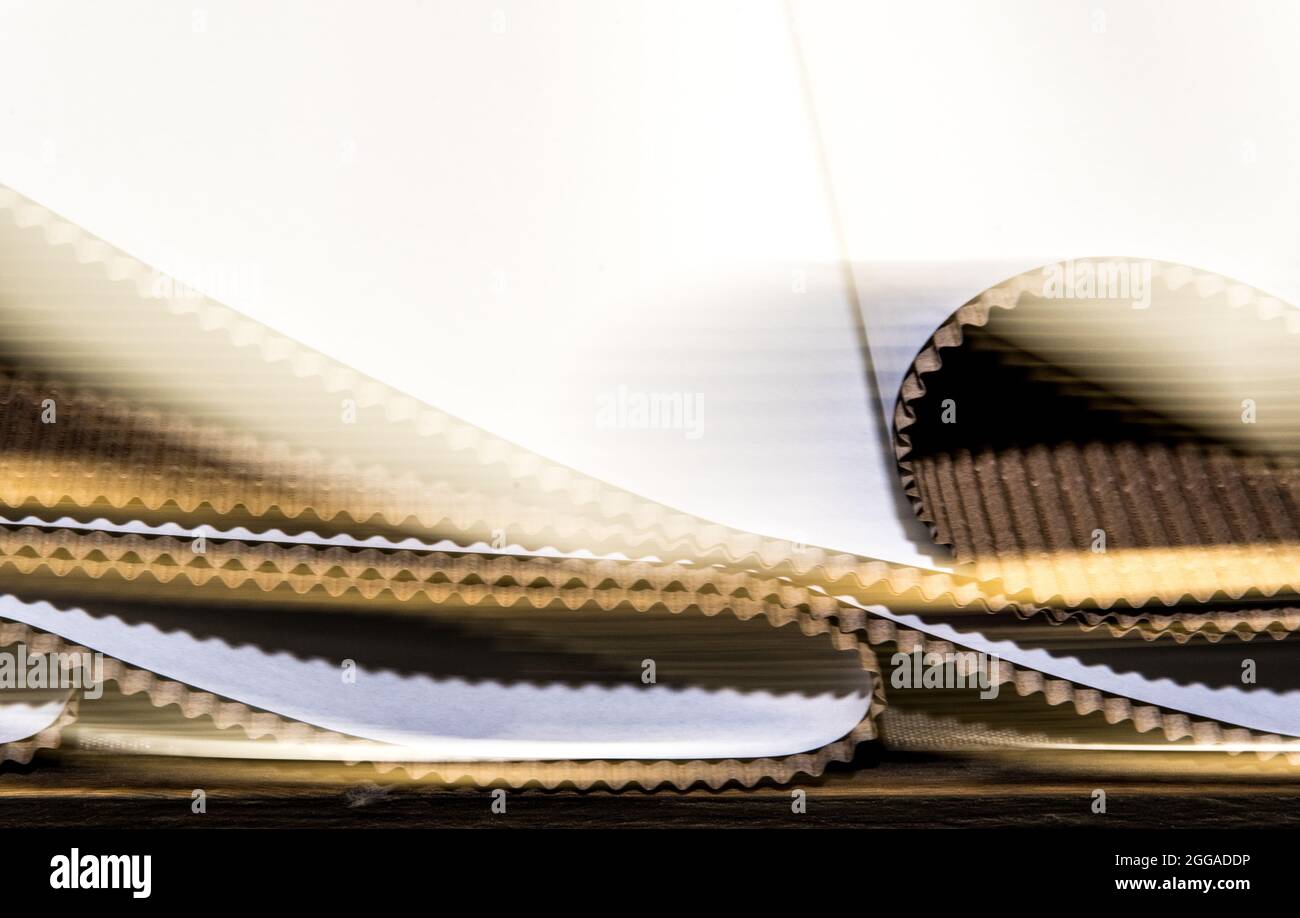 Paper is converted into corrugated cardboard made of multiple ...