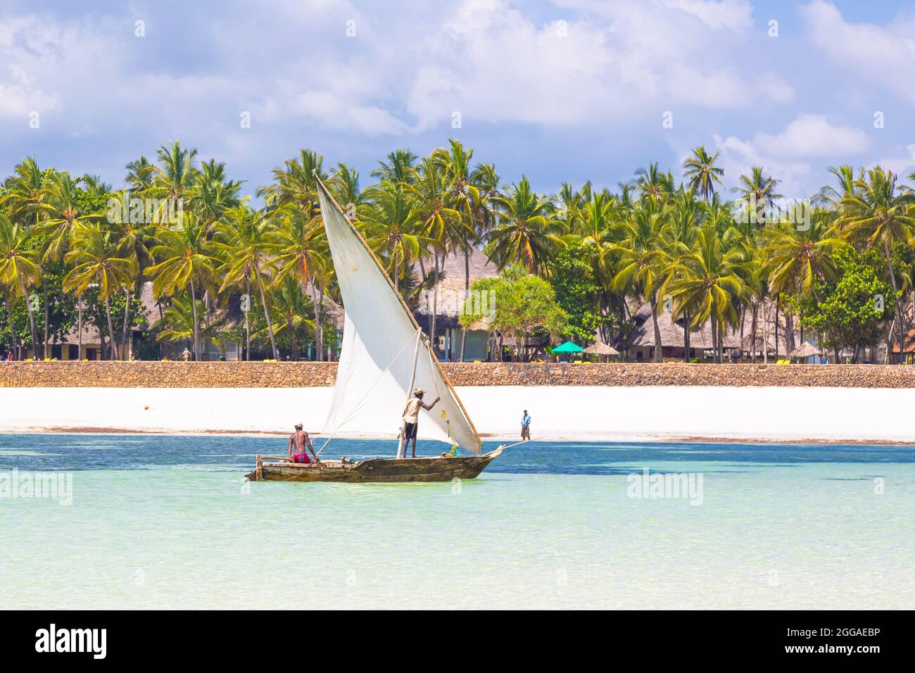Beach near the ocean and the boat swimming along it Stock Photo - Alamy