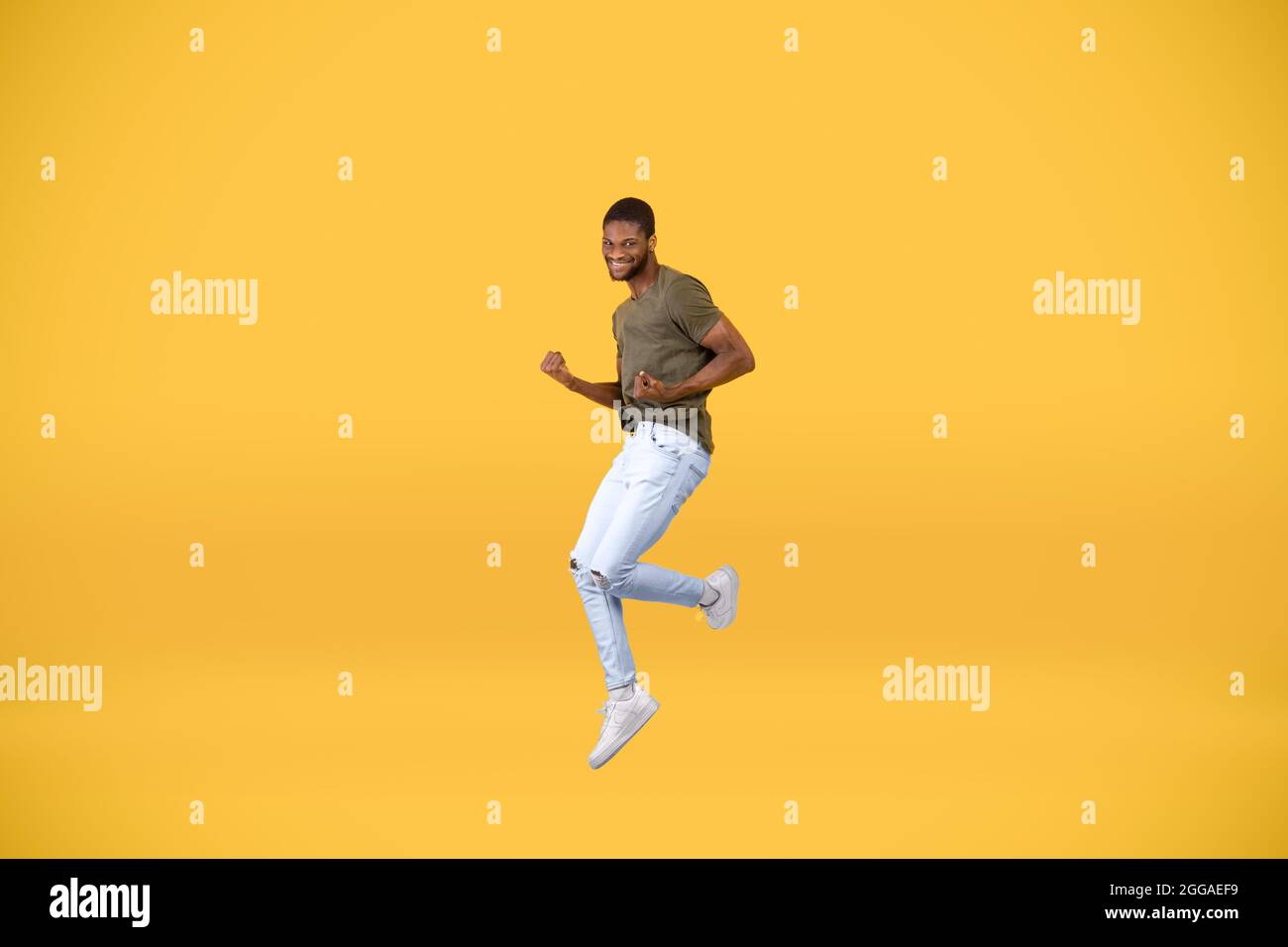 Joy of victory. Excited african american man gesturing yes and jumping ...