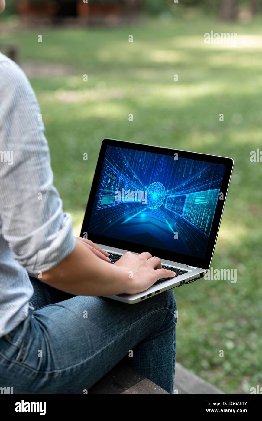 Woman Busy Typing On Laptop Sitting Outside Her Garden Side View ...