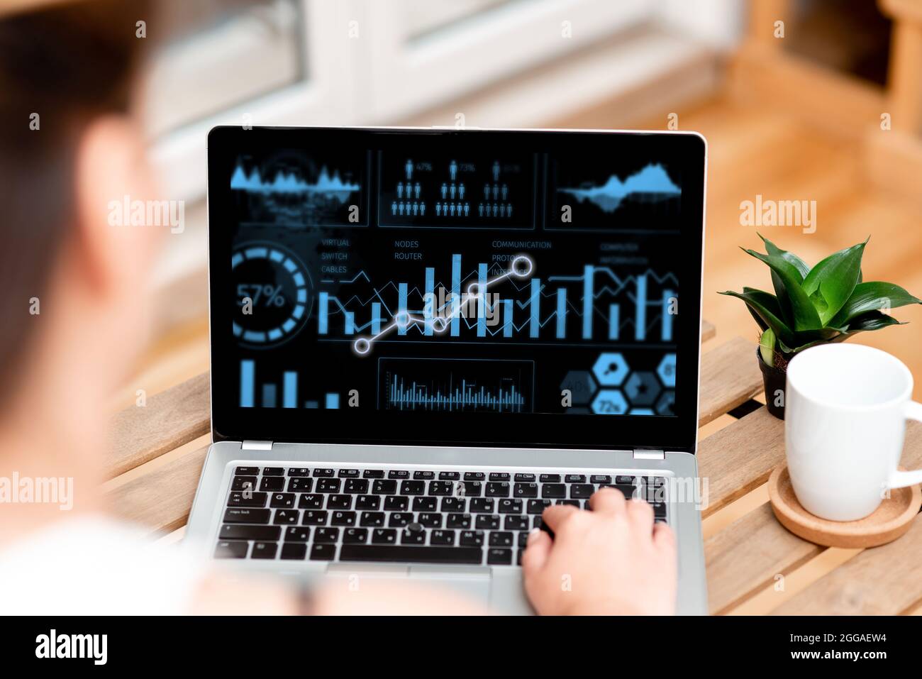 Woman Busy Typing On His Laptop Beside Coffe Mug And Plant ...