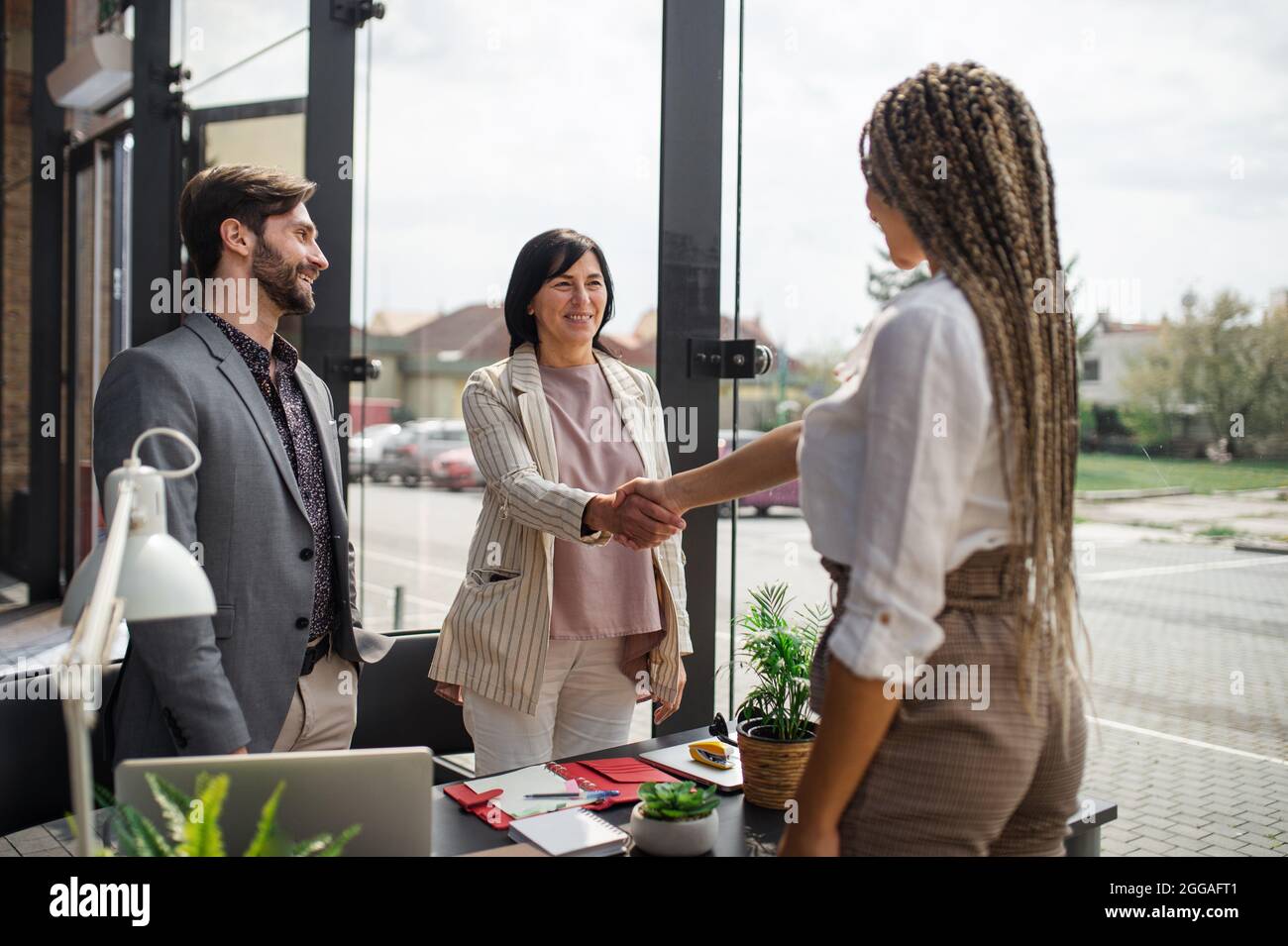 Young woman having job interview and shaking hands in office, business ...