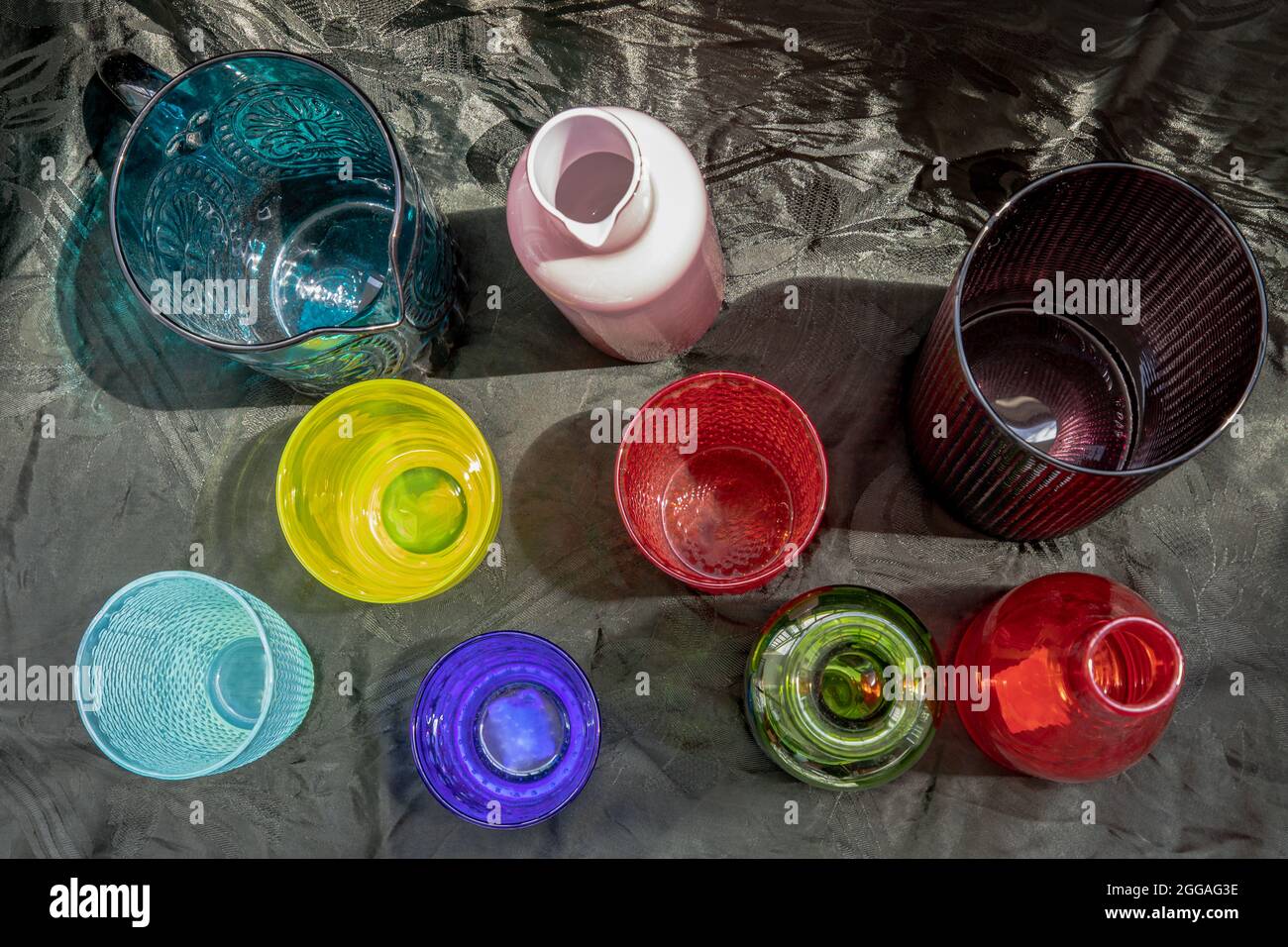 Many Different glass jar and glass cups and surface reflections on a ...
