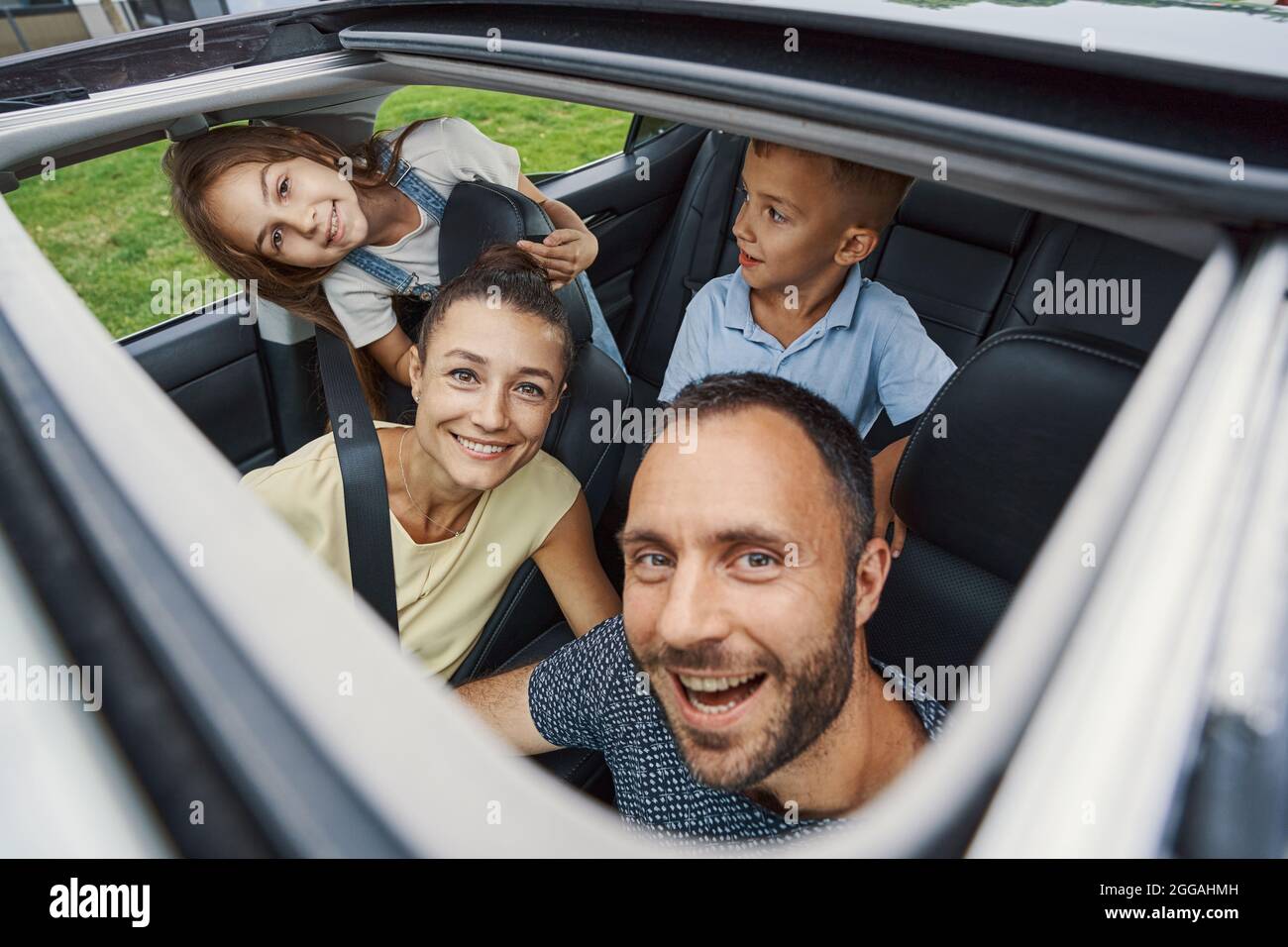 Family of four feeling excited before the road trip Stock Photo - Alamy Family of four feeling excited before the road trip Stock Photo - Alamy
