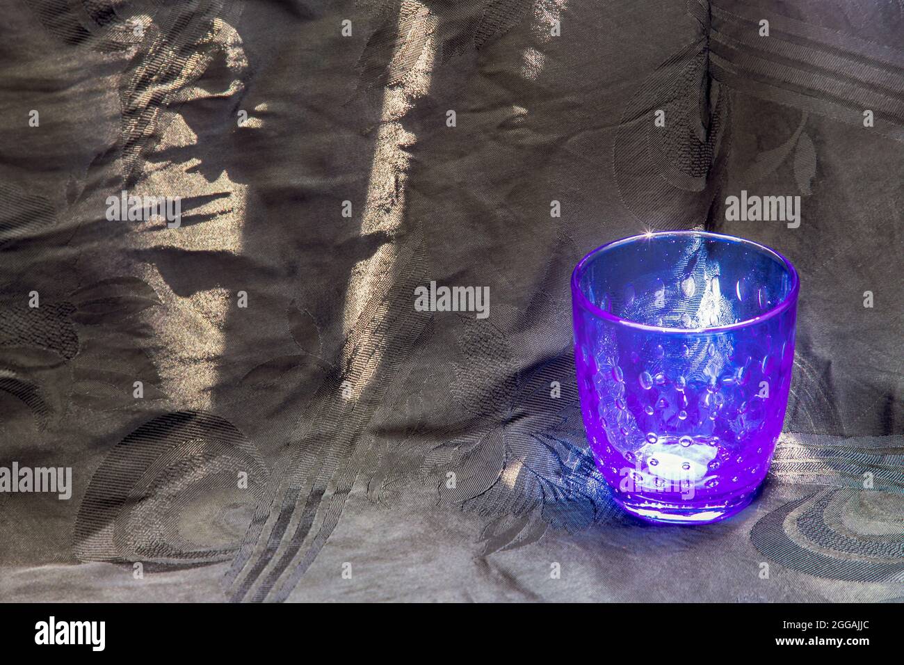 Colored transparent blue glass cup for water drinking and surface ...