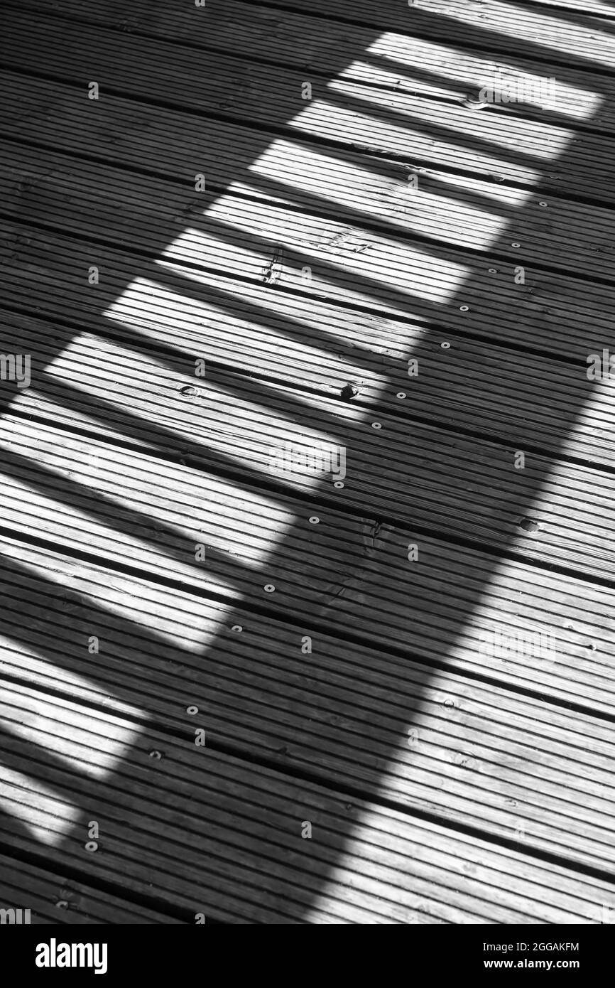 shadow of a railing on wood Stock Photo - Alamy