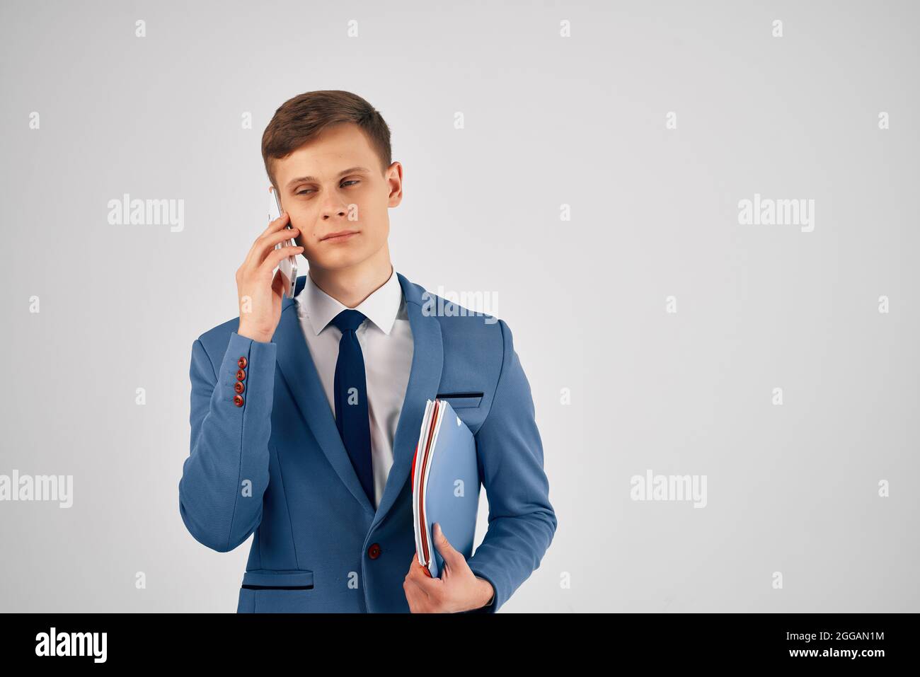 a man in a suit with a folder in his hands documents professional work ...