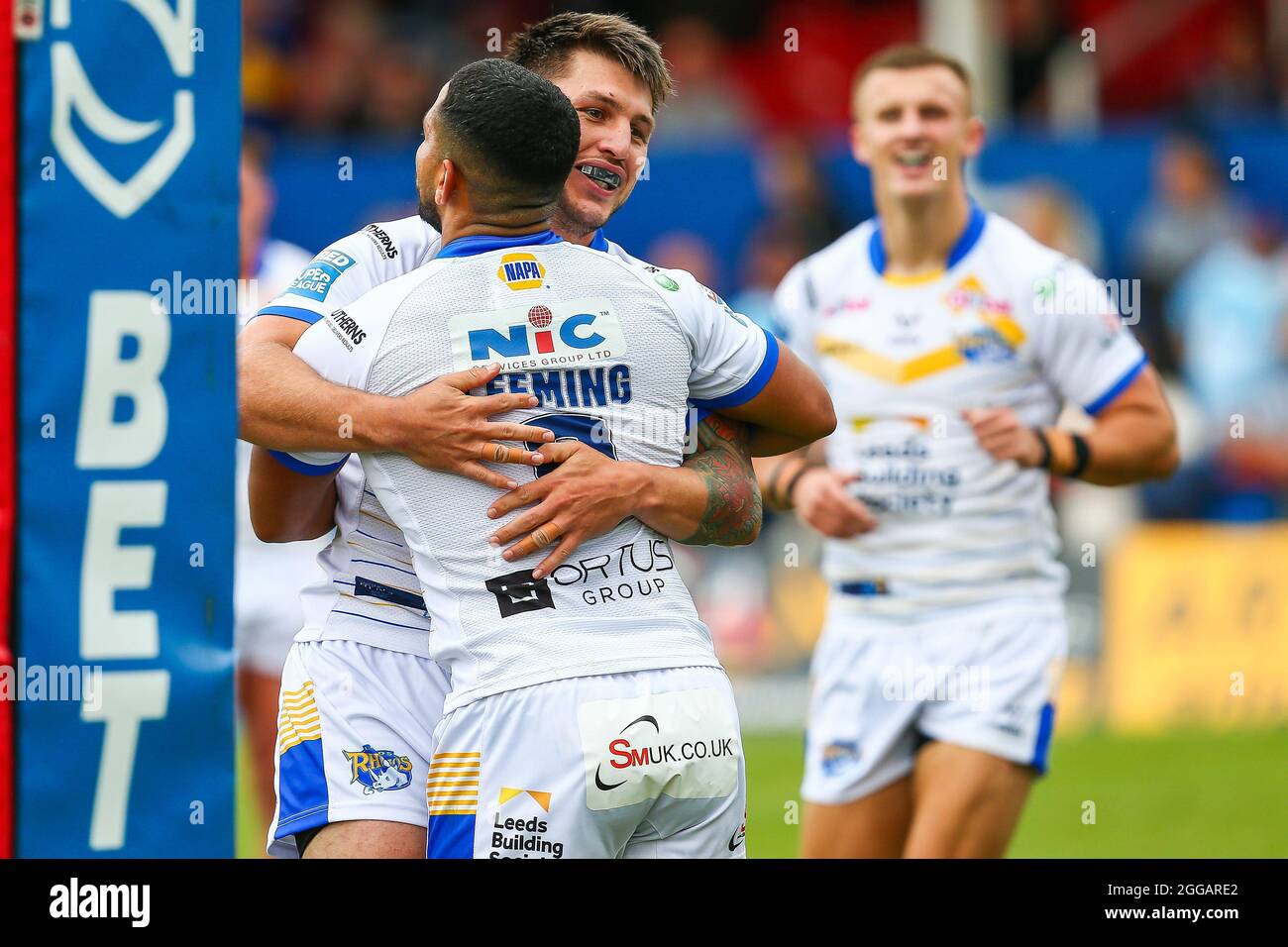 Kruise Leeming ( 9 ) of Leeds Rhinos celebrates his try with Tom ...