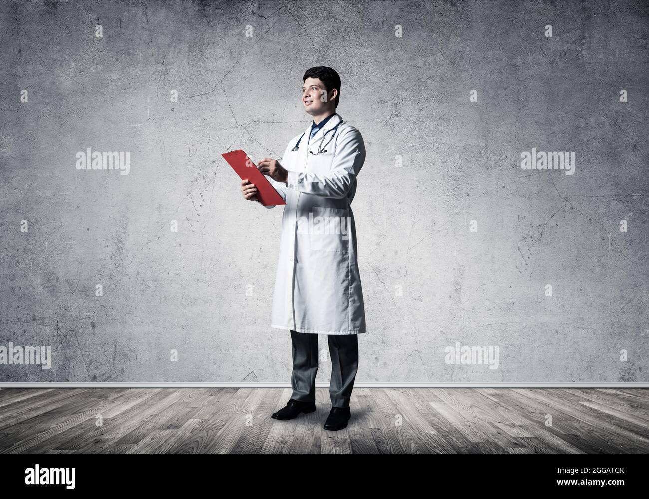 Young doctor with red document plate Stock Photo - Alamy
