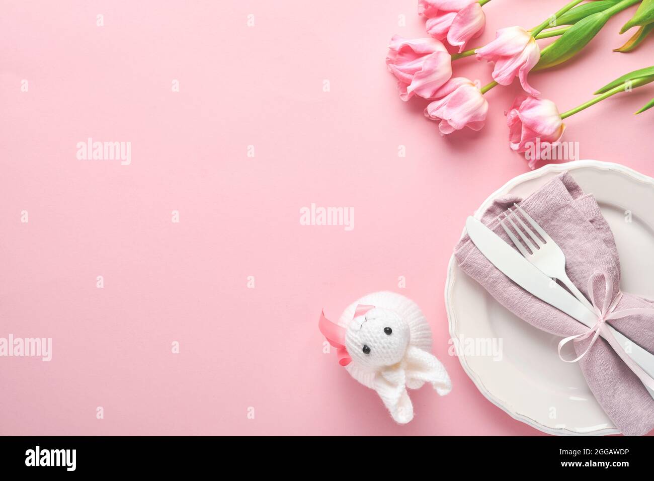 Easter table setting with floral decor on pink table. Elegance dinner ...