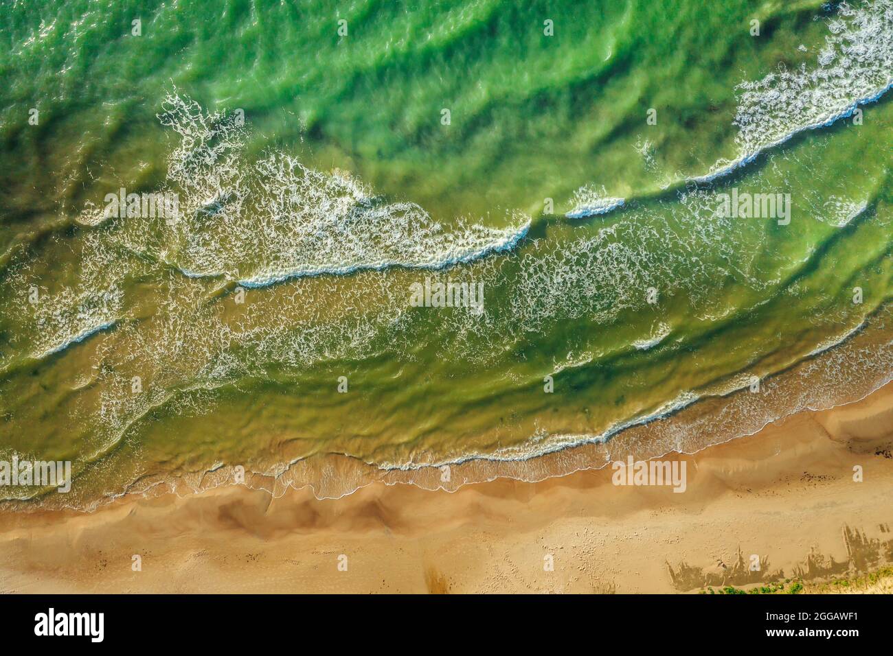 Top view shot of a beach being washed off by the waves of a sea Stock ...