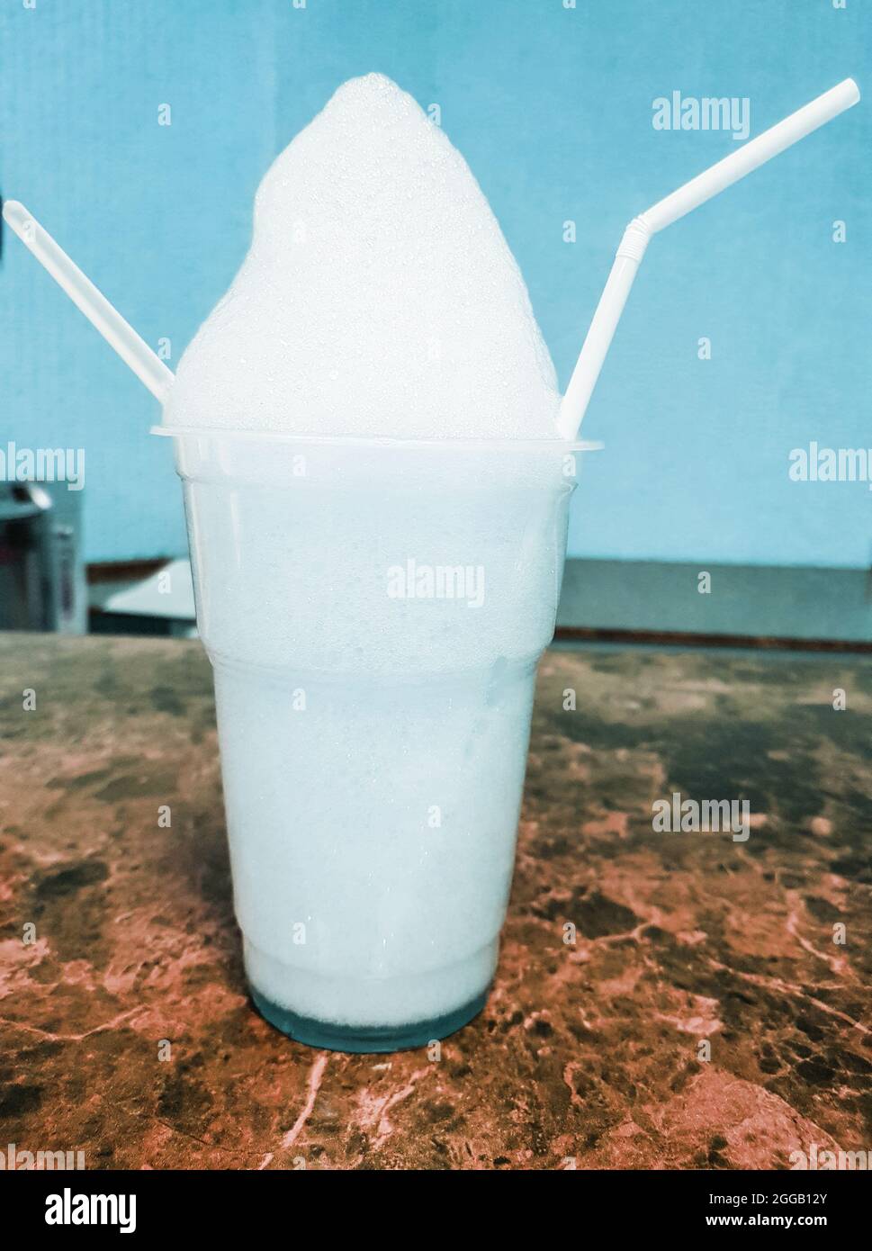 Oxygen cocktail with a straw and a spoon in a plastic cup, a useful ...