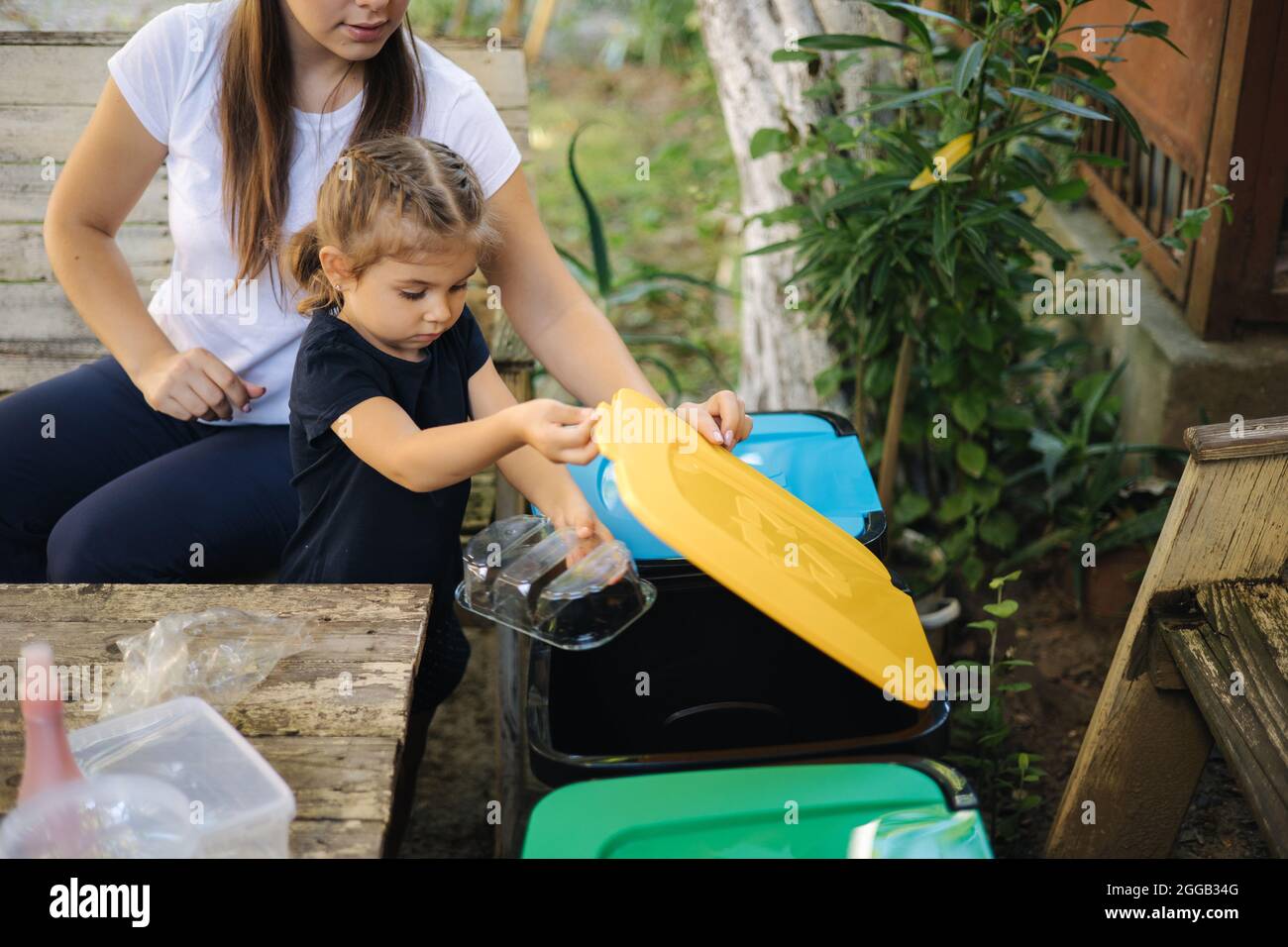 Caring about nature. Young mom with her little daughter preparing for ...