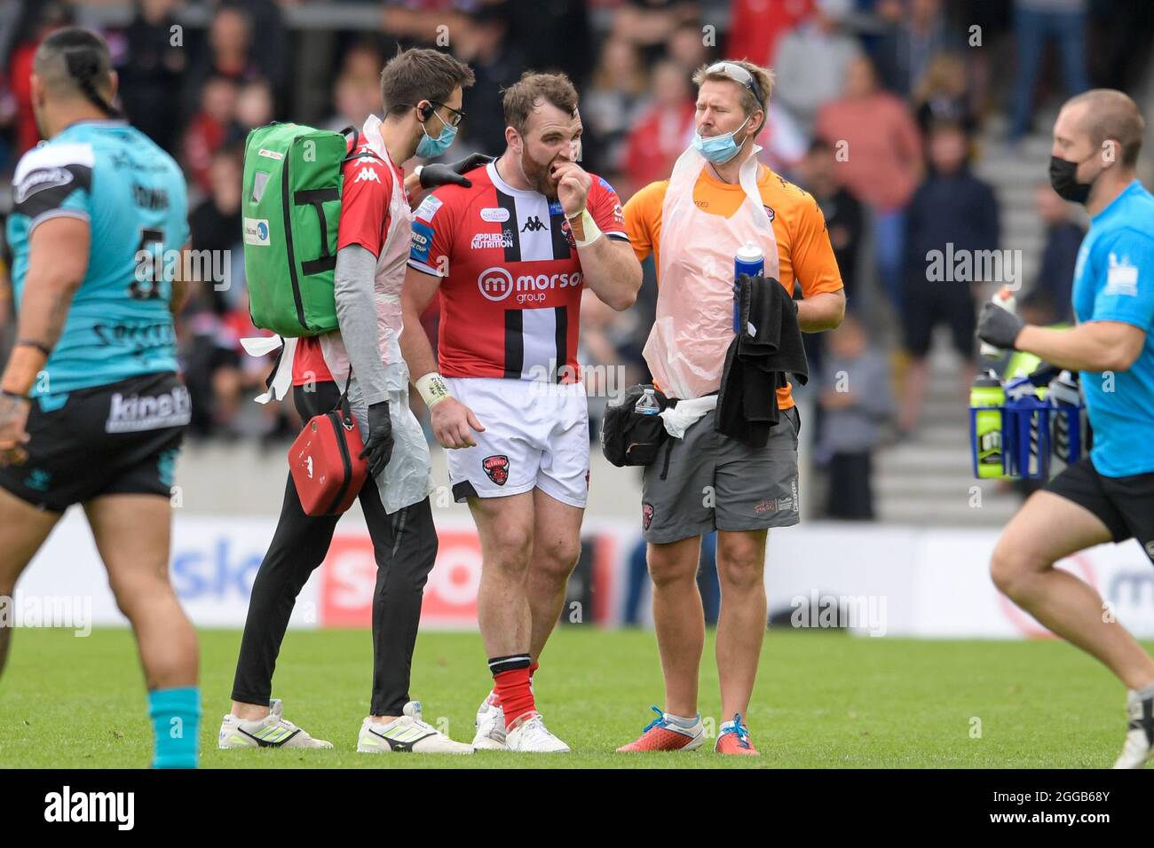 Greg Burke (16) of Salford Red Devils receives treatment on the pitch ...
