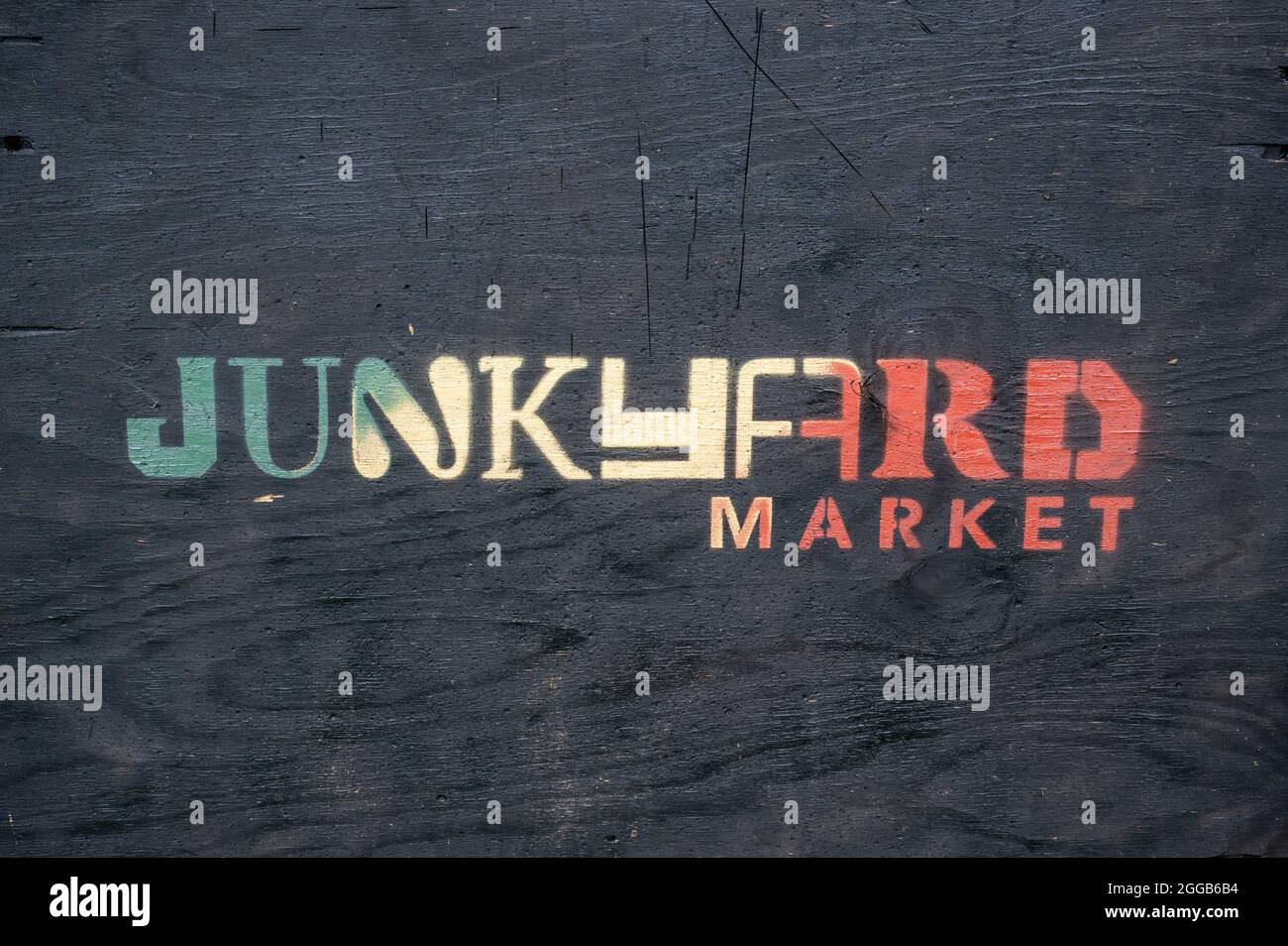 Junkyard market sign in colour on a black background Stock Photo - Alamy