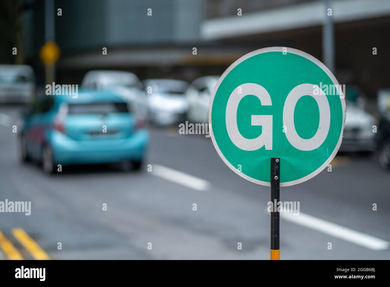 Go Sign, green road sign with with word GO street in background Stock ...