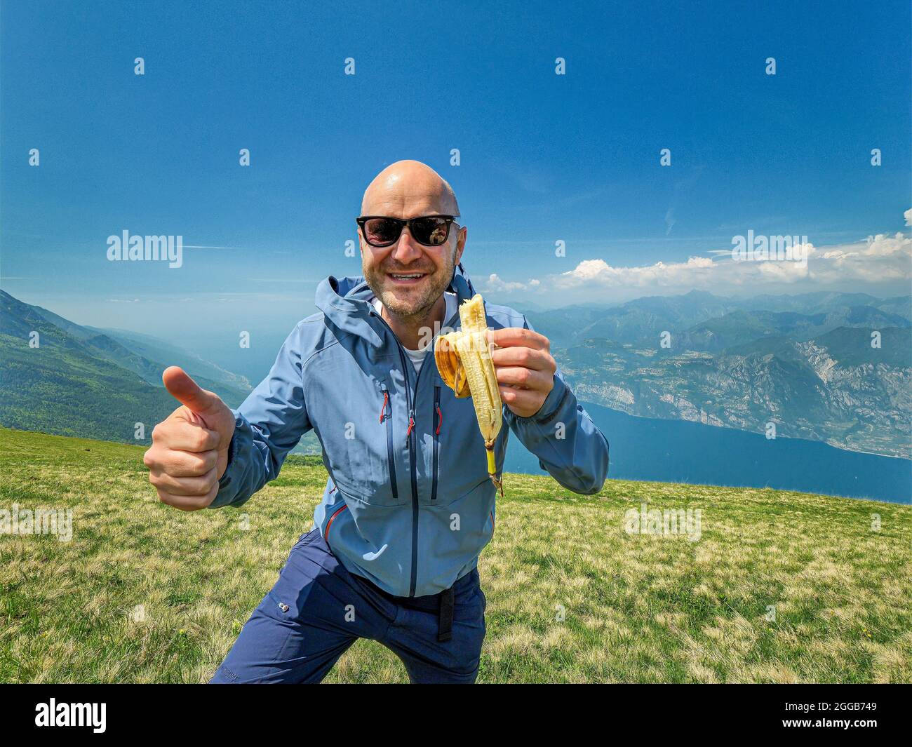 Hiking Man in Italy on top of the mountain Stock Photo - Alamy