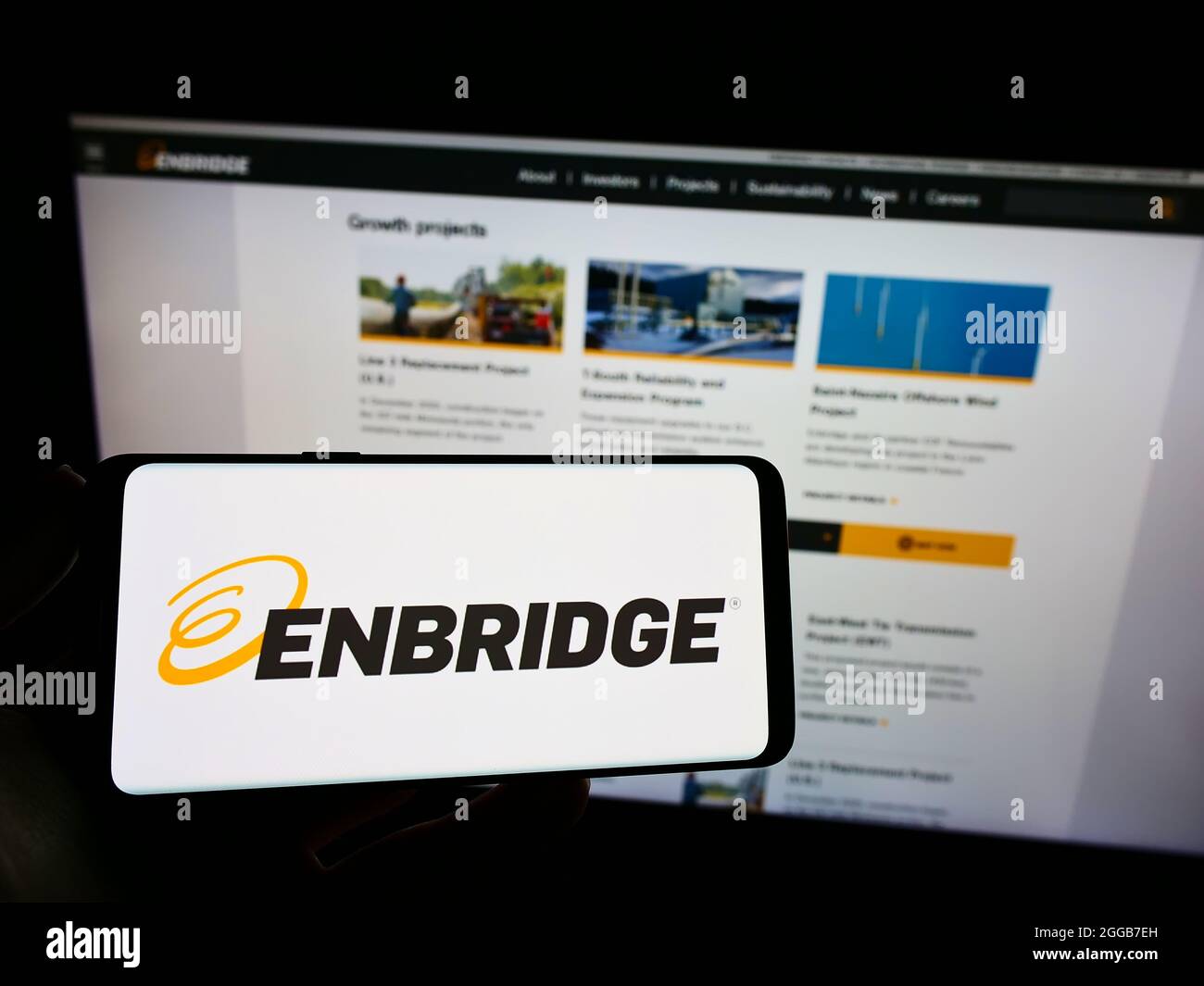 Person holding cellphone with logo of Canadian pipeline company ...