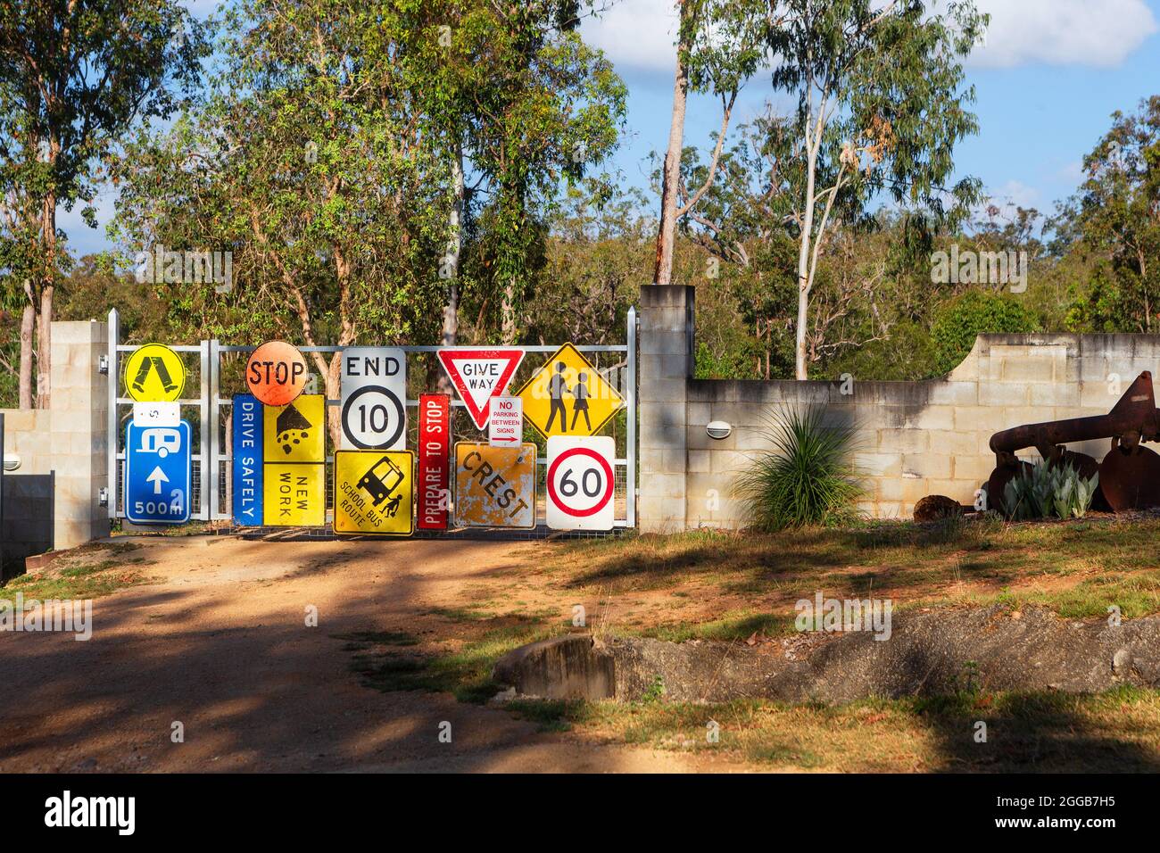 Random signs attached to a farm gate Stock Photo - Alamy