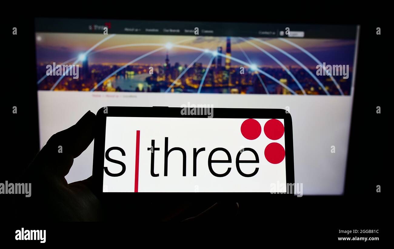 Person holding smartphone with logo of British recruitment company ...