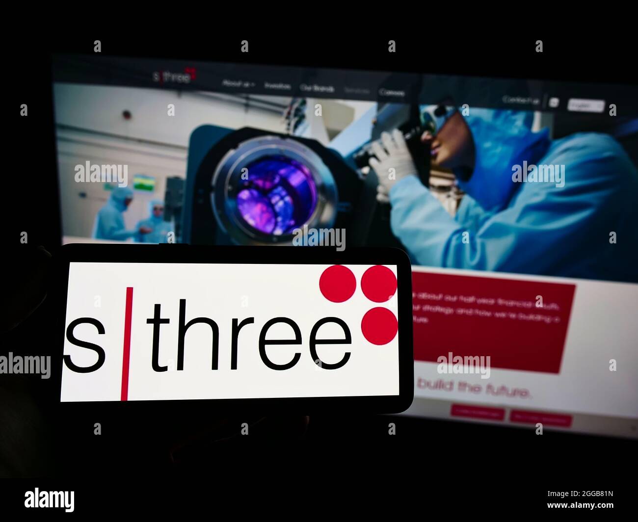 Person holding cellphone with logo of British recruitment company ...